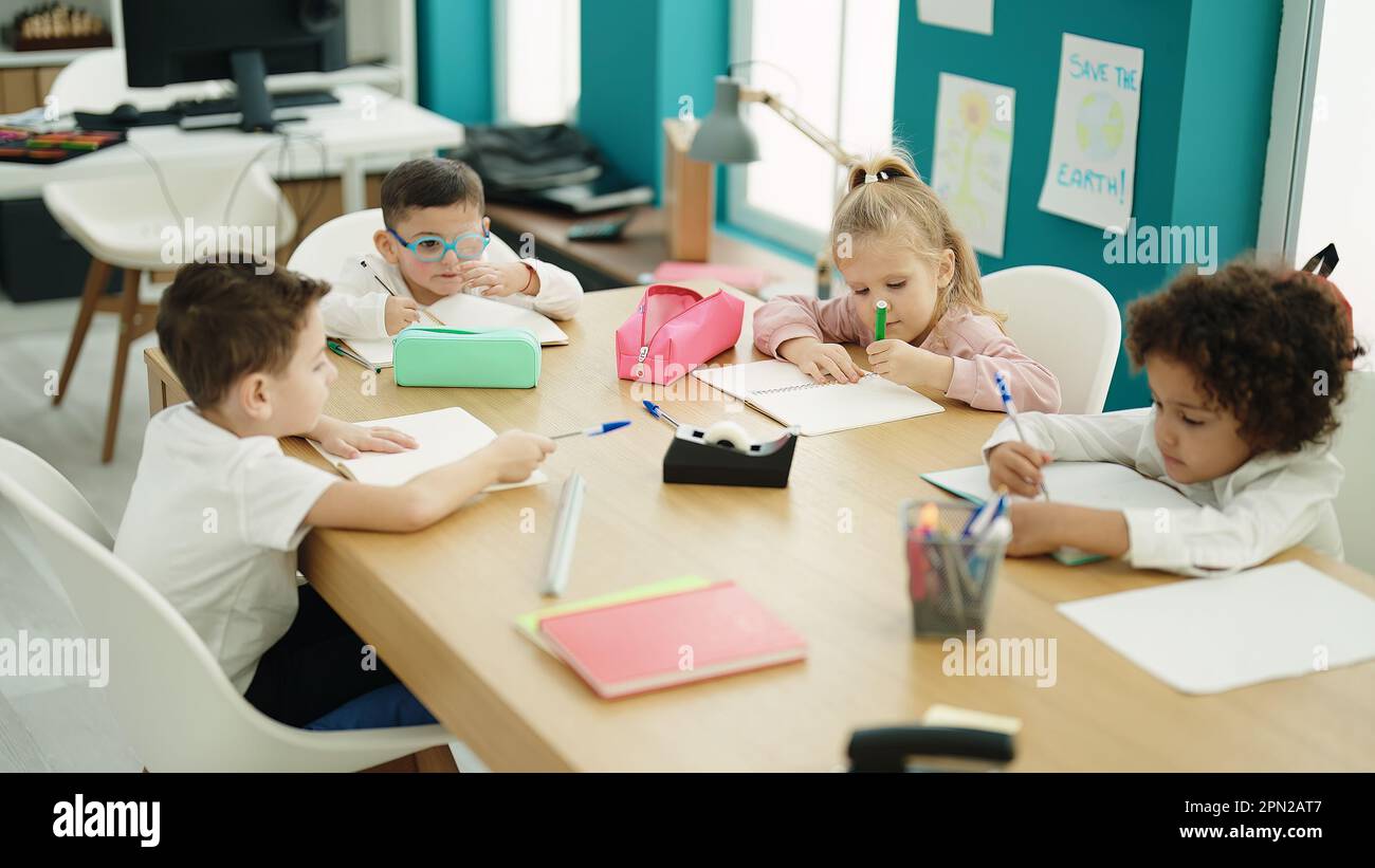 Group of kids students sitting on table studying at classroom Stock ...