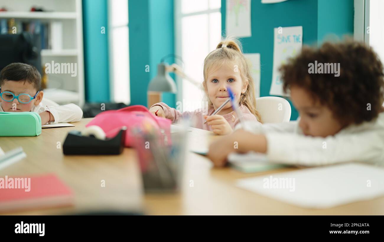 Group of kids students sitting on table studying at classroom Stock ...