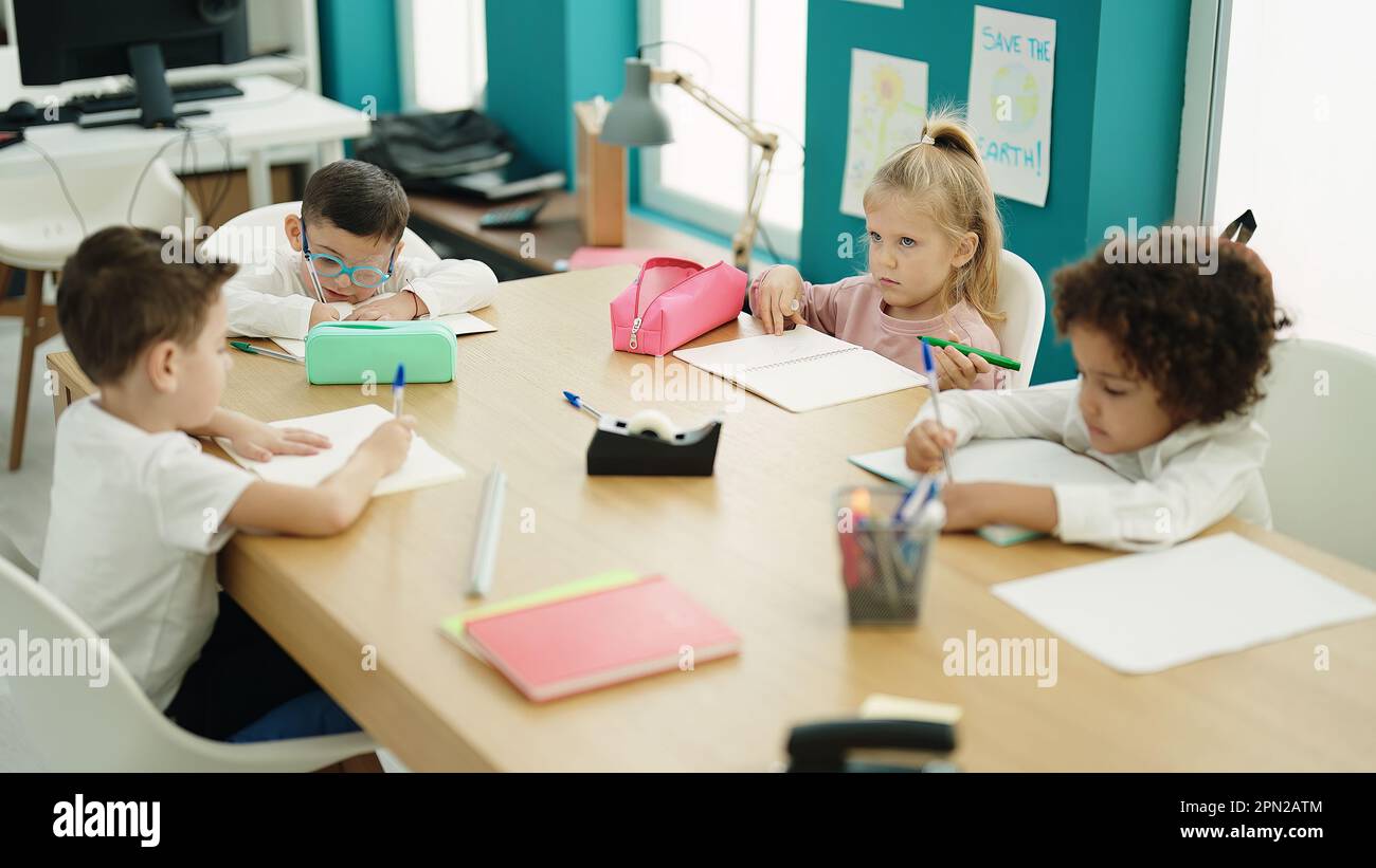 Group of kids students sitting on table studying at classroom Stock ...