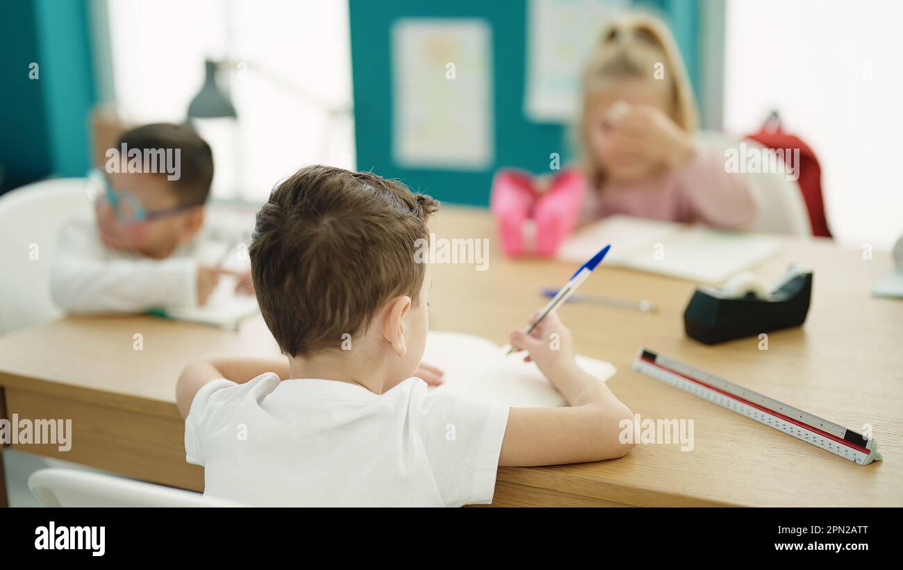 Group of kids students sitting on table studying at classroom Stock ...