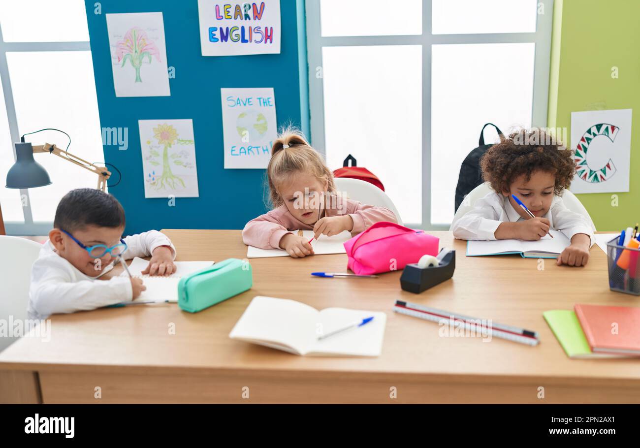 Group of kids students sitting on table studying at classroom Stock ...