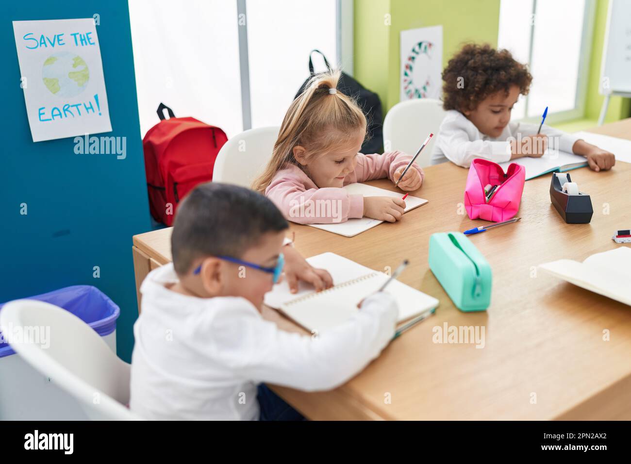 Group of kids students sitting on table studying at classroom Stock ...