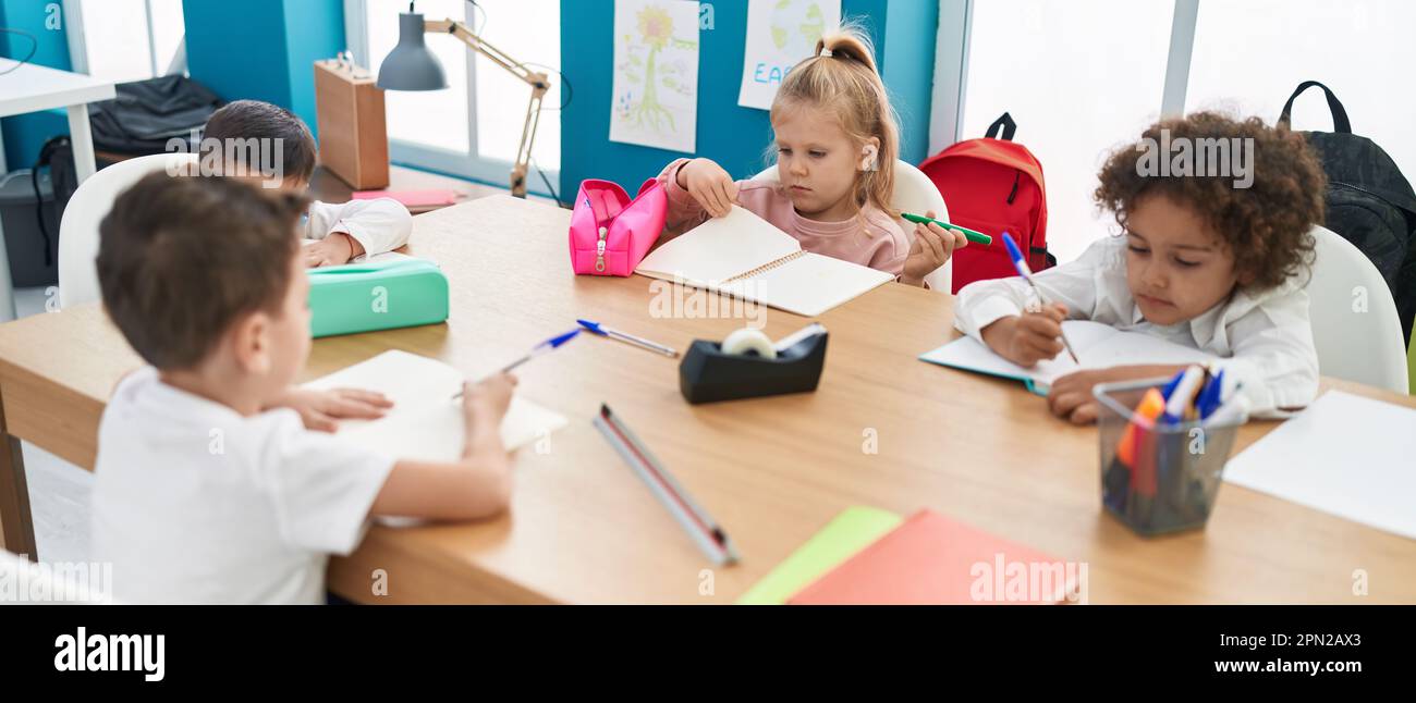 Group of kids students sitting on table studying at classroom Stock ...