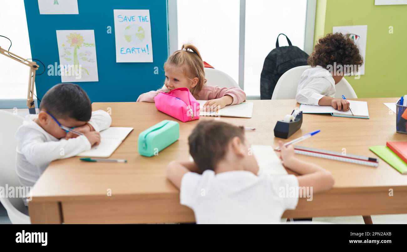 Group of kids students sitting on table studying at classroom Stock ...