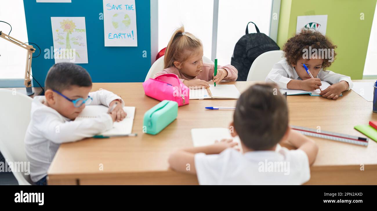 Group of kids students sitting on table studying at classroom Stock ...