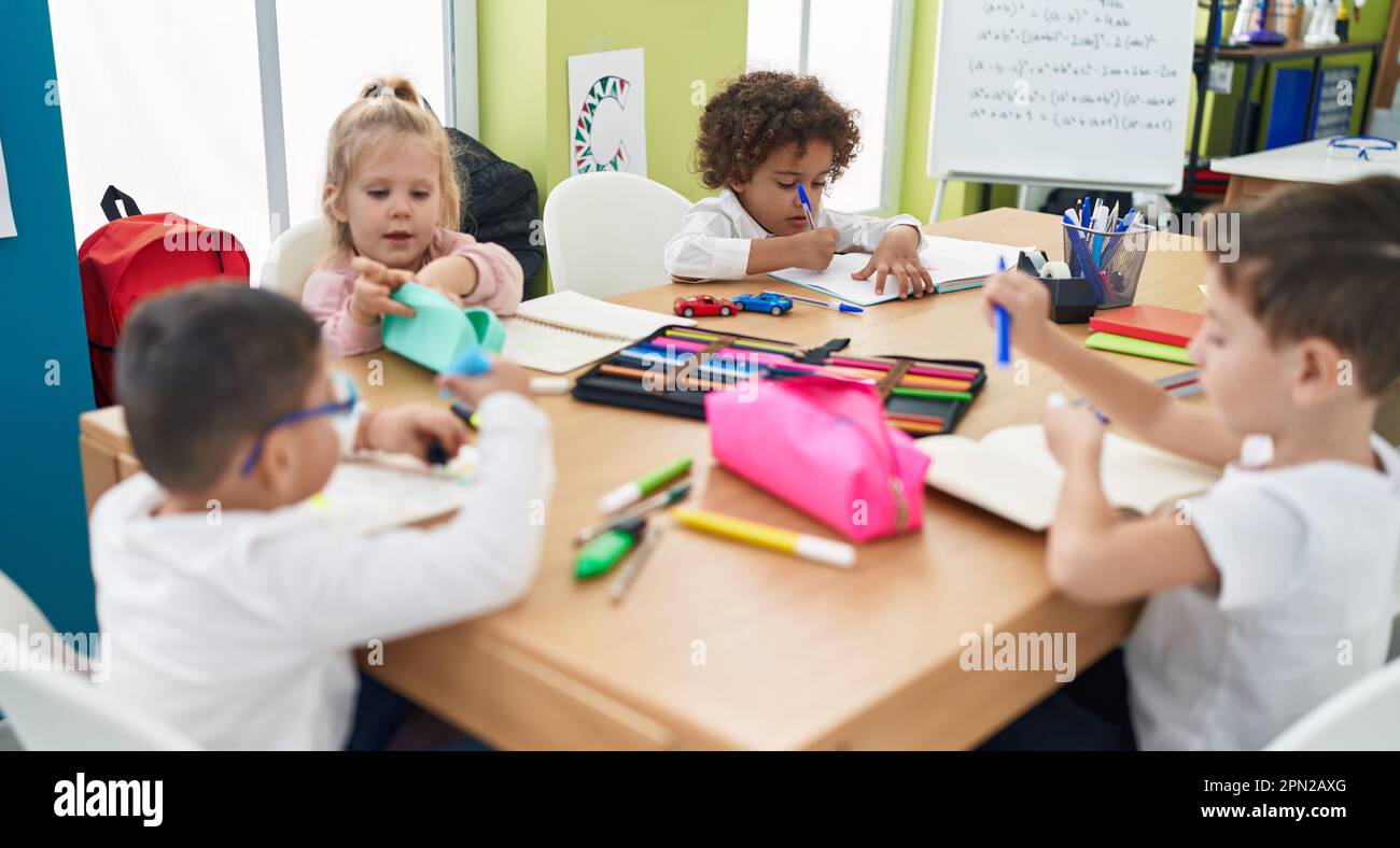 Group of kids students sitting on table studying at classroom Stock ...