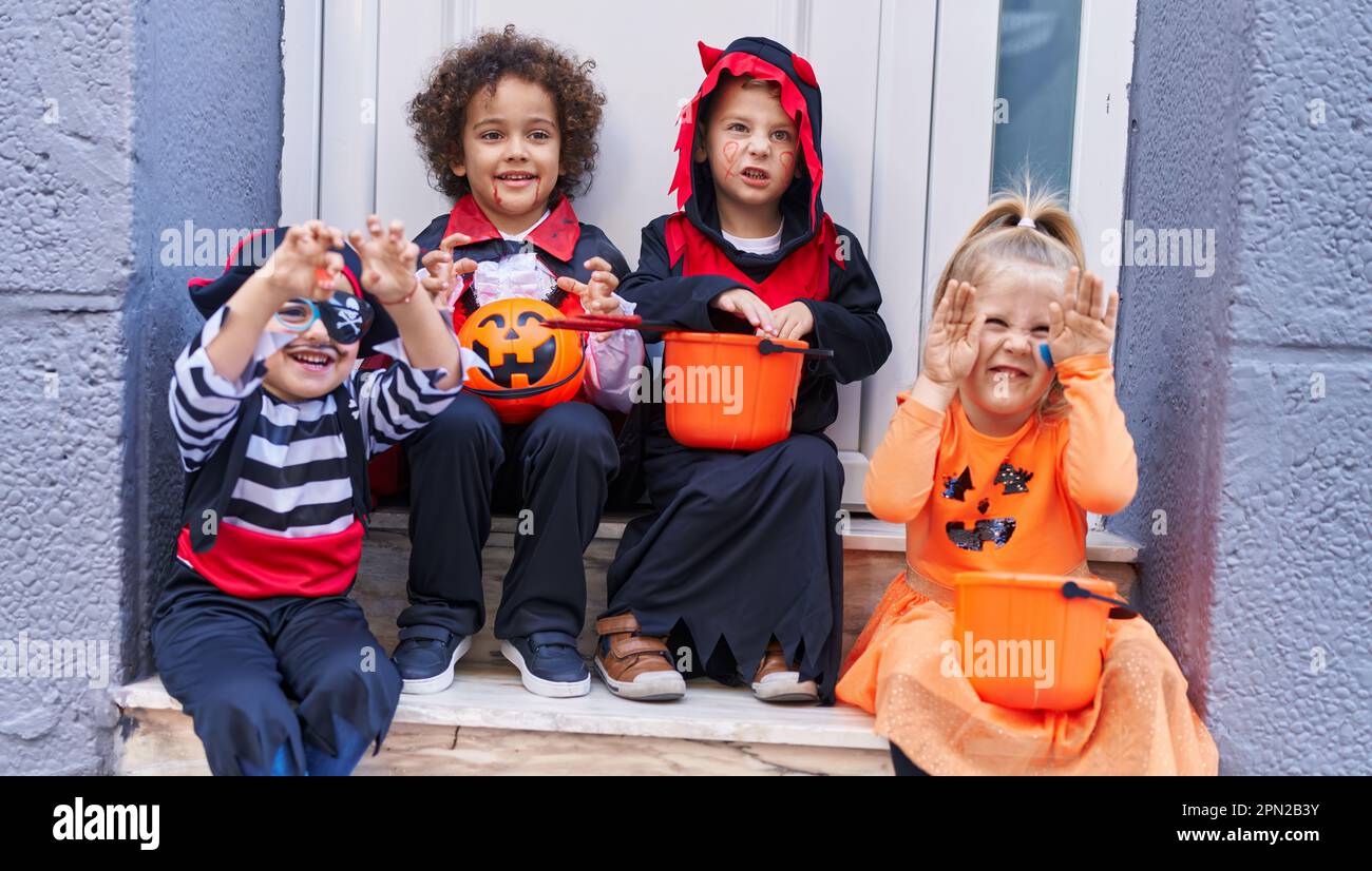 Group of kids wearing halloween costume doing fear gesture at street ...