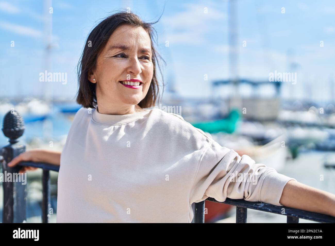 Middle age woman smiling confident standing at seaside Stock Photo - Alamy