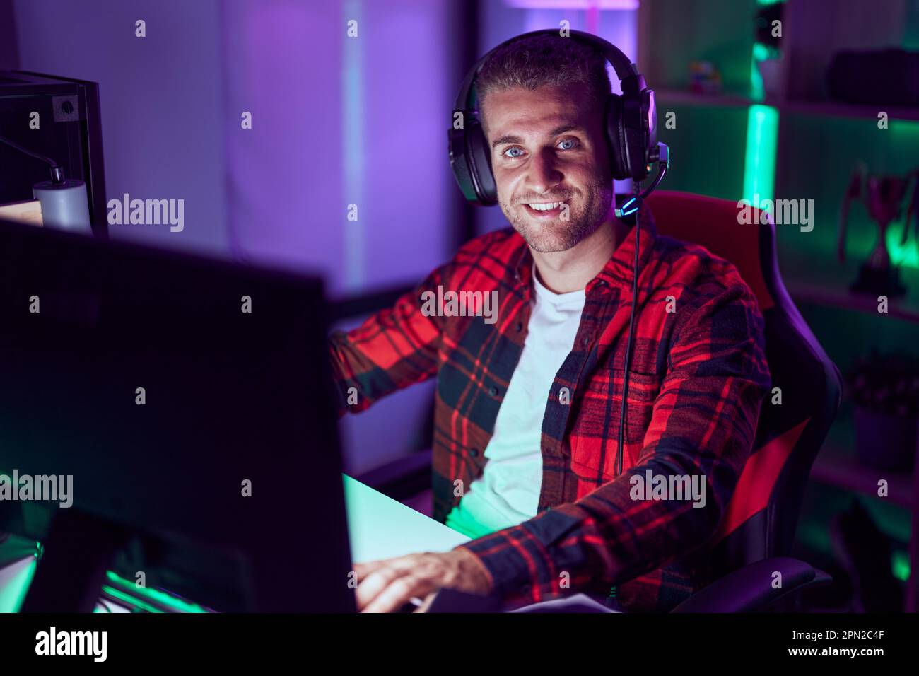 Young caucasian man streamer playing video game using computer at ...