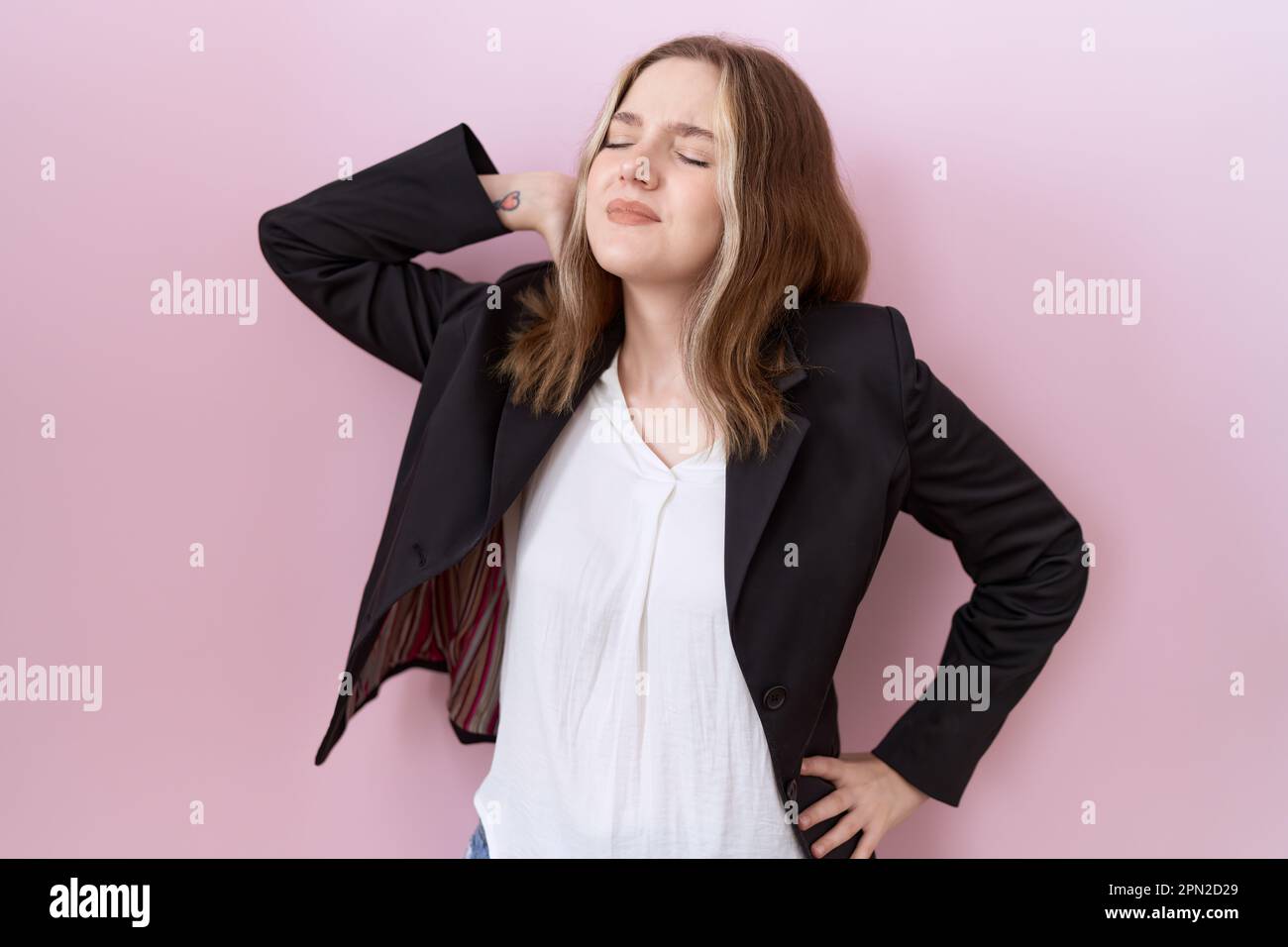 Young caucasian business woman wearing black jacket suffering of neck ...