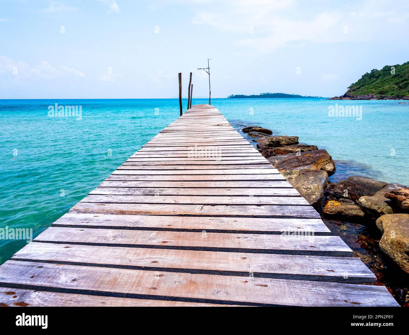 Wooden bridge heading to the blue sea. Brown wood plank pathway bridge ...