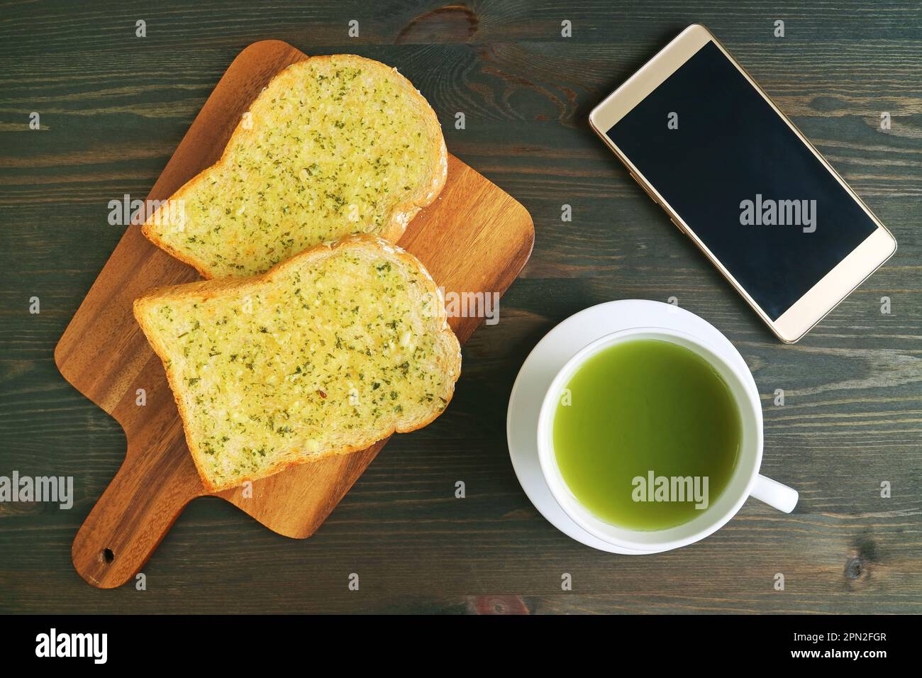 Top View of Garlic Butter Toasts with Hot Green Tea and Empty Screen ...