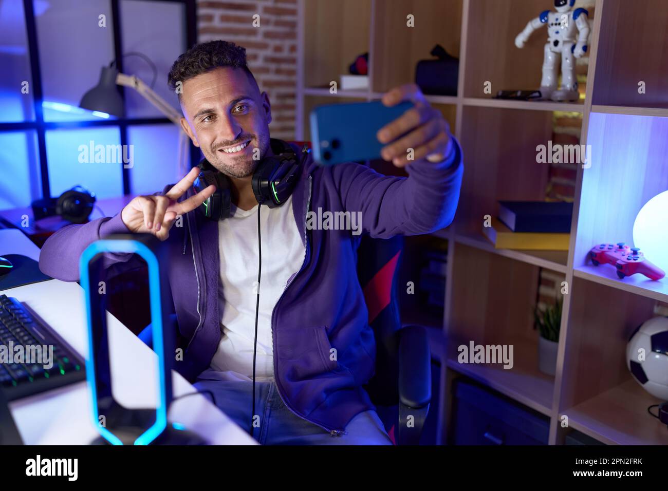 Young hispanic man streamer smiling confident make selfie by smartphone ...