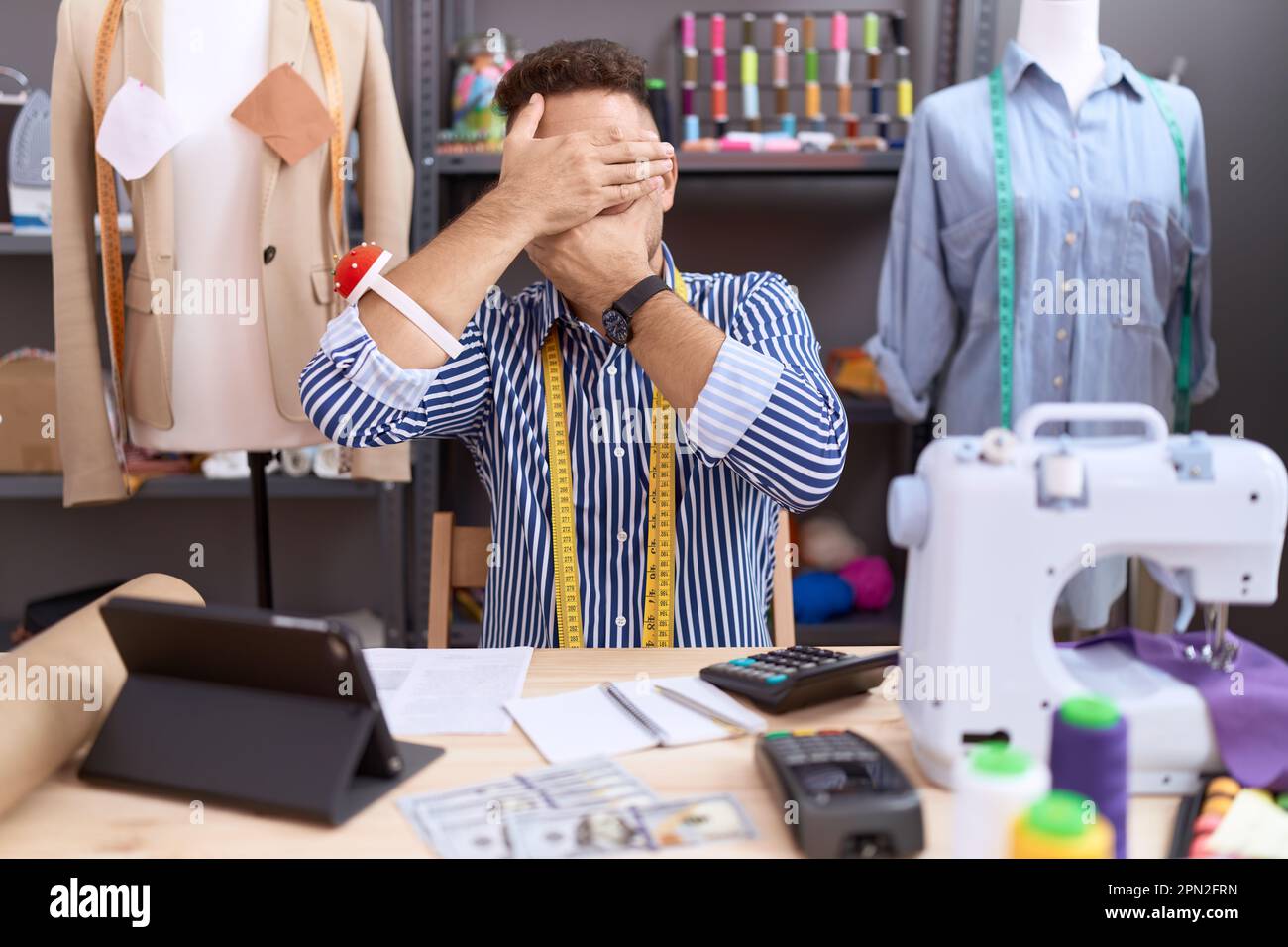 Hispanic man with beard dressmaker designer working at atelier covering ...