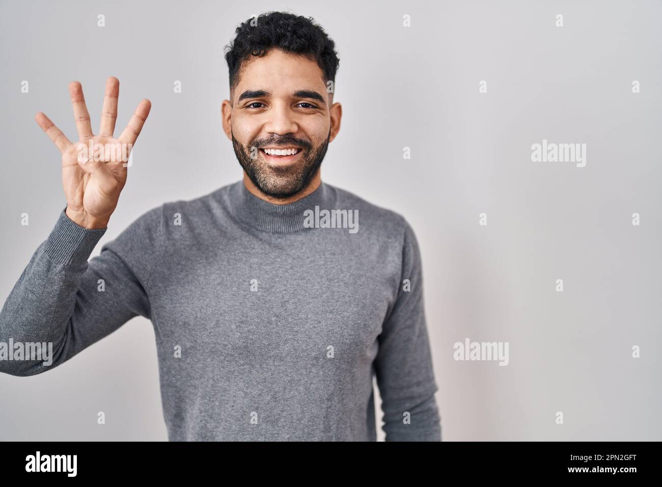 Hispanic man with beard standing over white background showing and ...