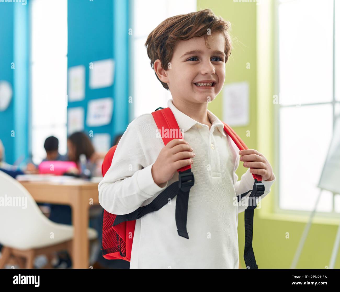Adorable caucasian boy student smiling confident standing at classroom ...