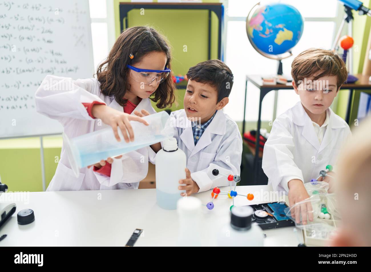 Group of kids students pouring liquid on bottl doing experiment at ...