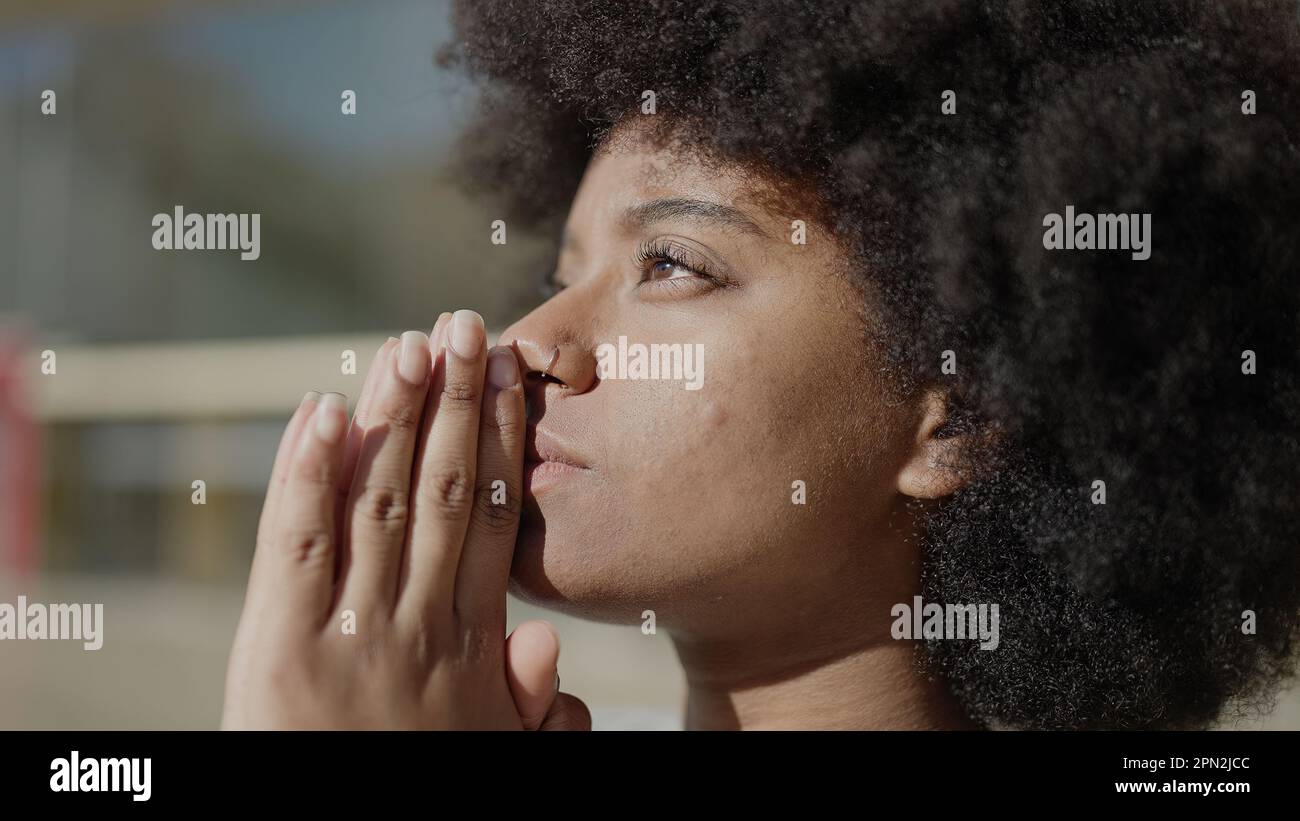 Black woman praying outside african hi-res stock photography and images ...