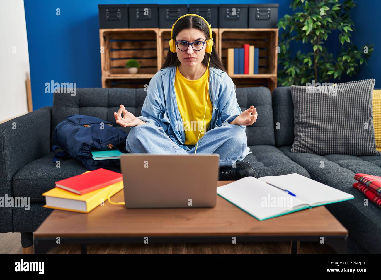 Young hispanic woman studying using computer laptop and headphones ...