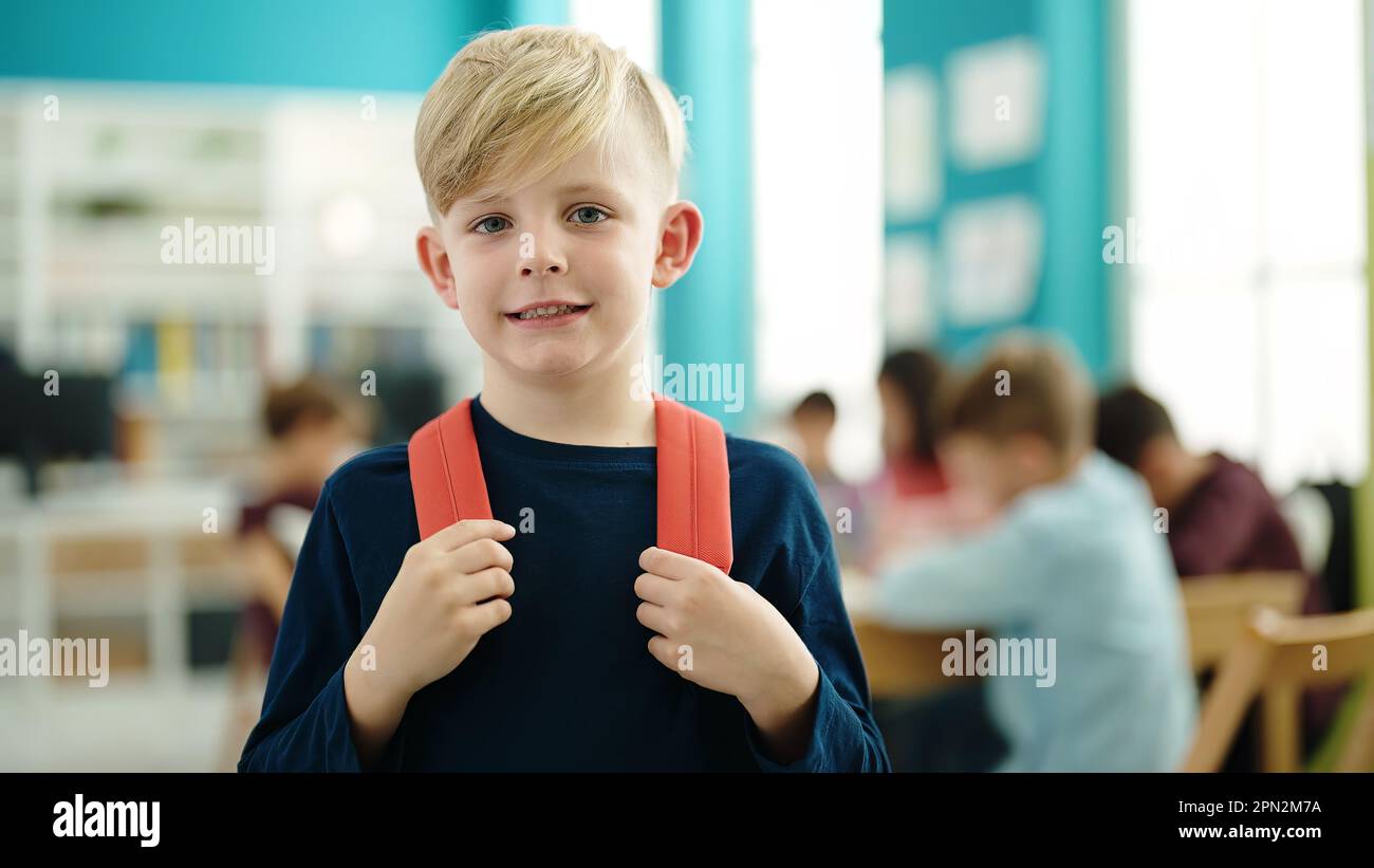 Adorable caucasian boy student smiling confident standing at classroom ...