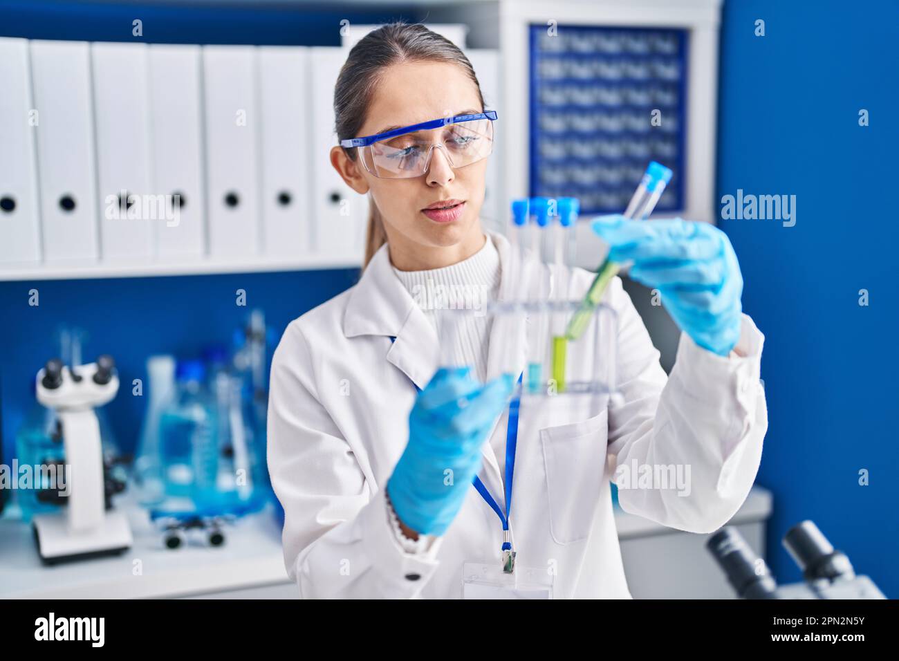 Young woman scientist holding test tubes at laboratory Stock Photo - Alamy