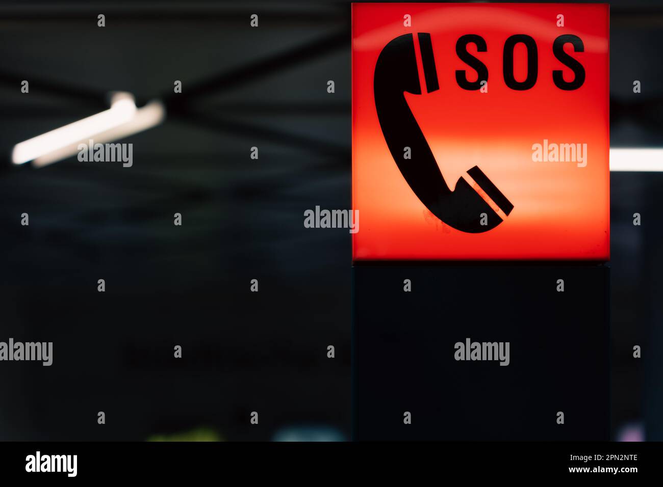 A large vibrant red sign with a phone icon and SOS on it Stock Photo ...
