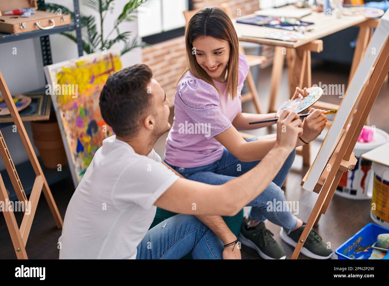 Man and woman artists couple smiling confident drawing at art studio ...