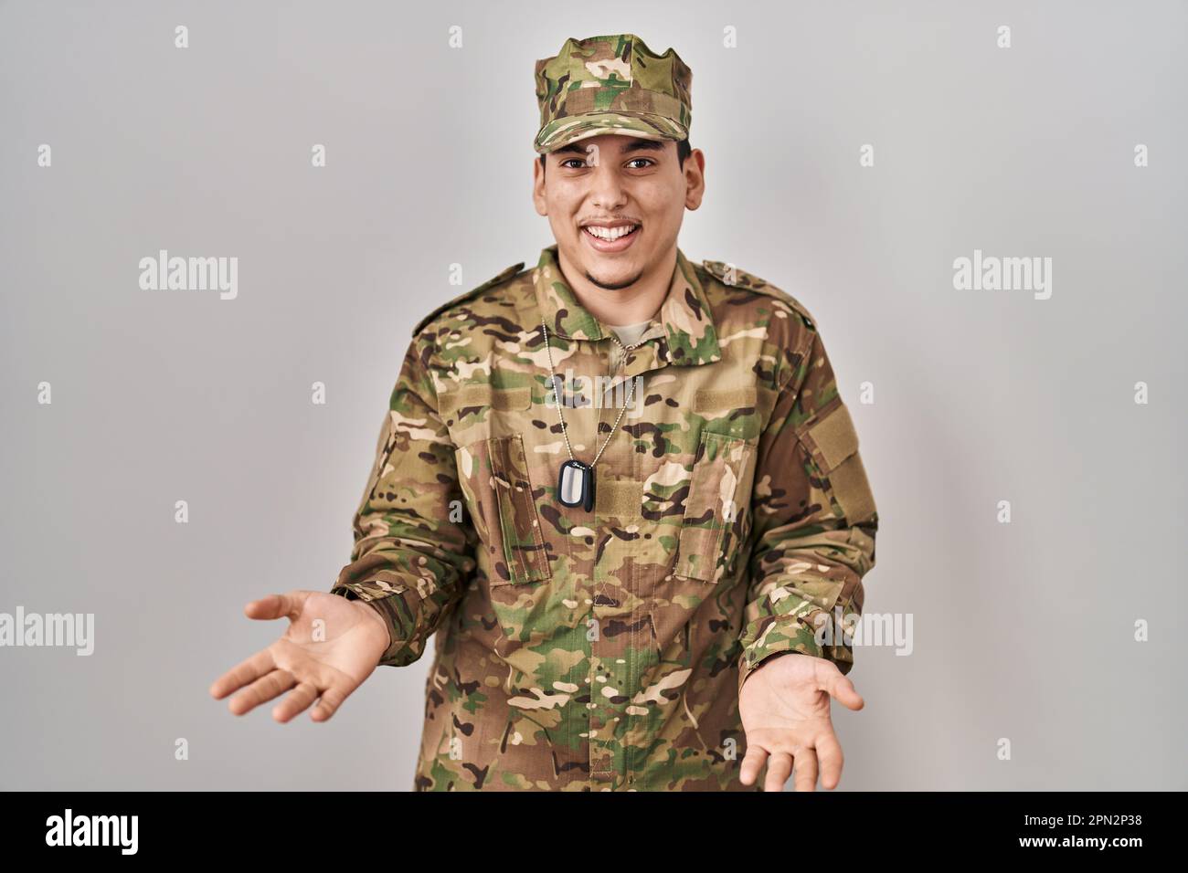 Young arab man wearing camouflage army uniform smiling cheerful with ...