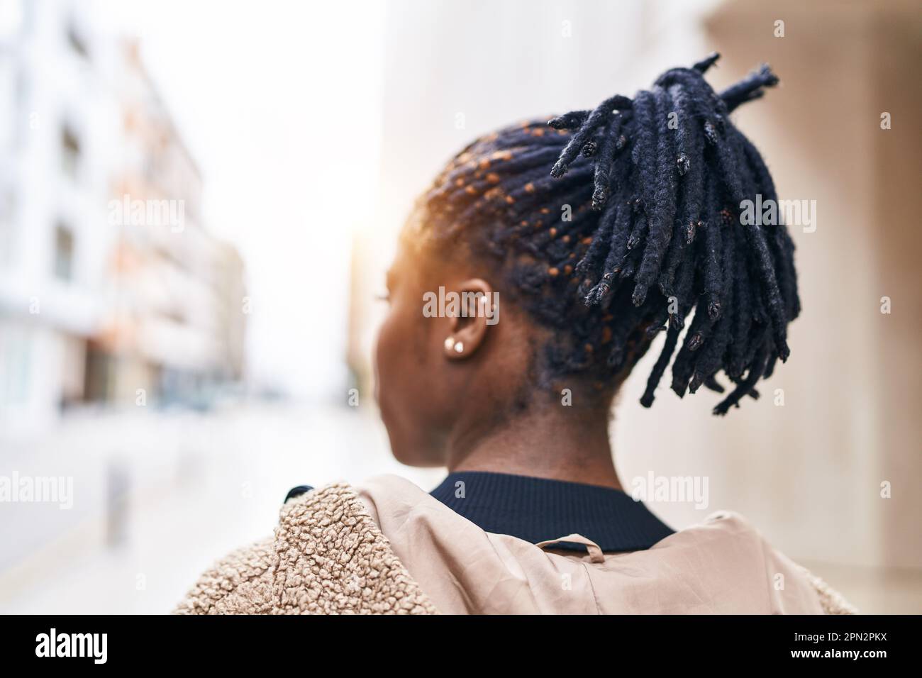 African american woman standing on back view at street Stock Photo - Alamy