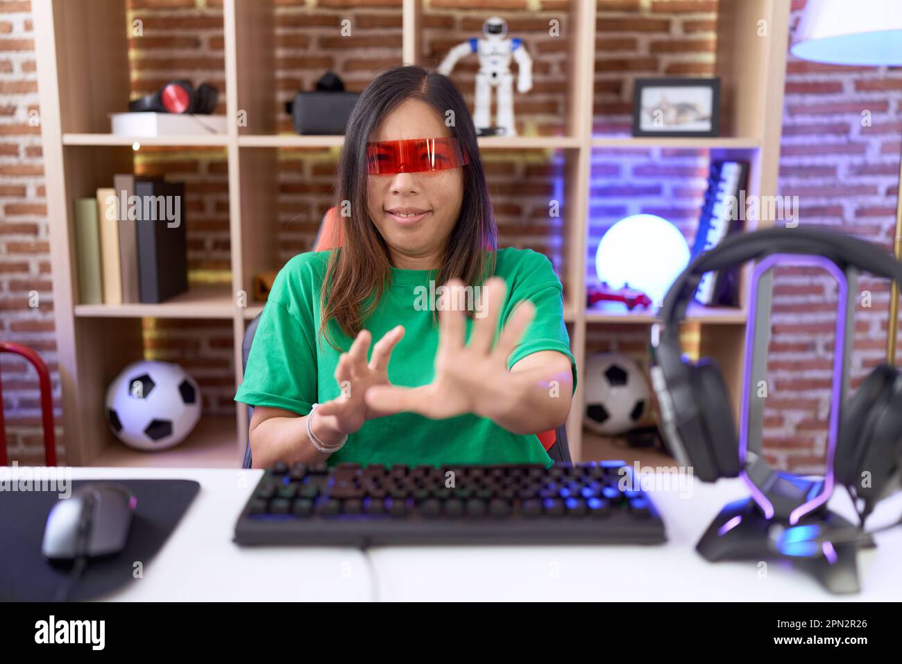 Middle age chinese woman wearing virtual reality glasses disgusted ...