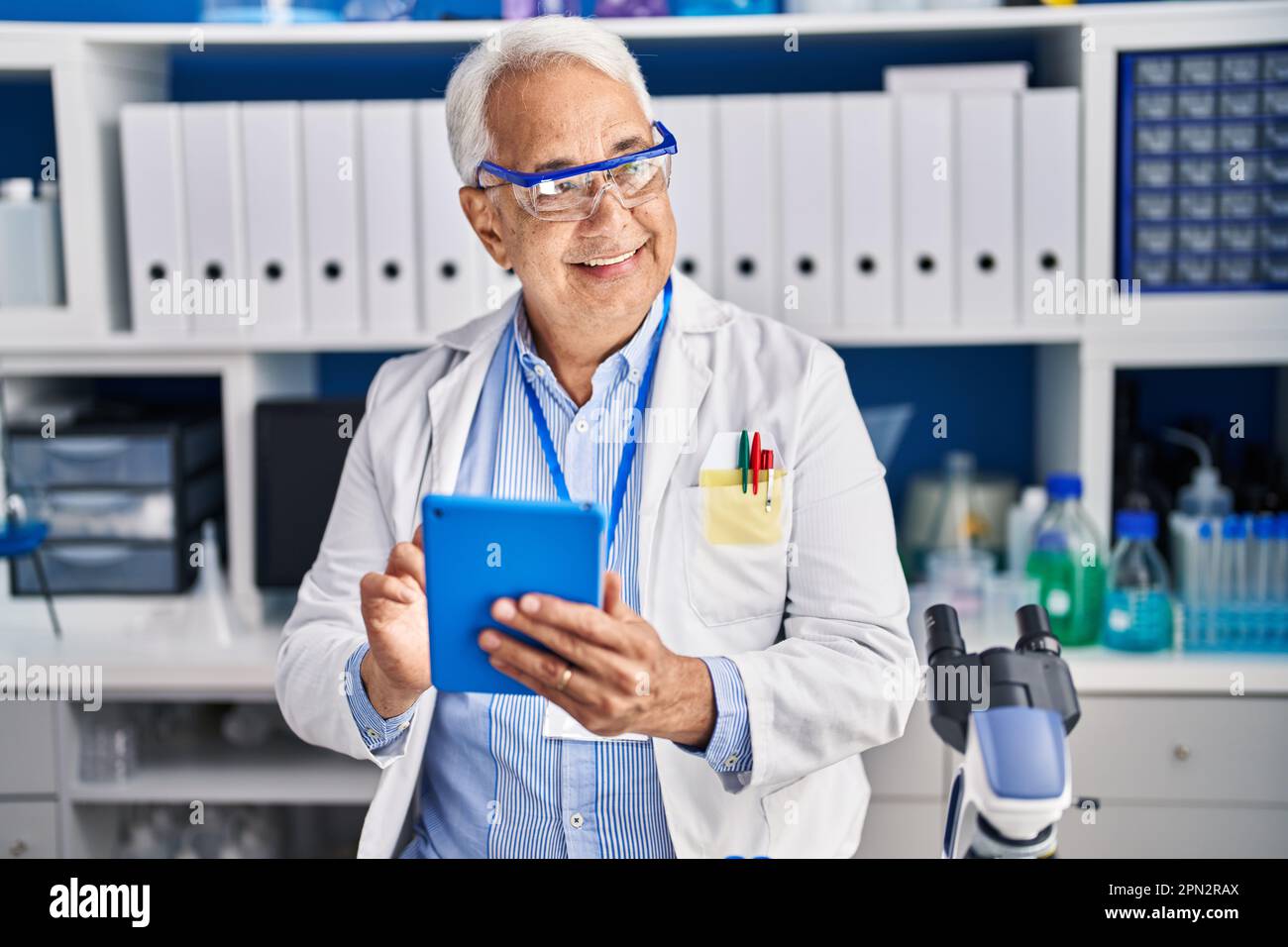 Senior man scientist using touchpad working at laboratory Stock Photo - Alamy