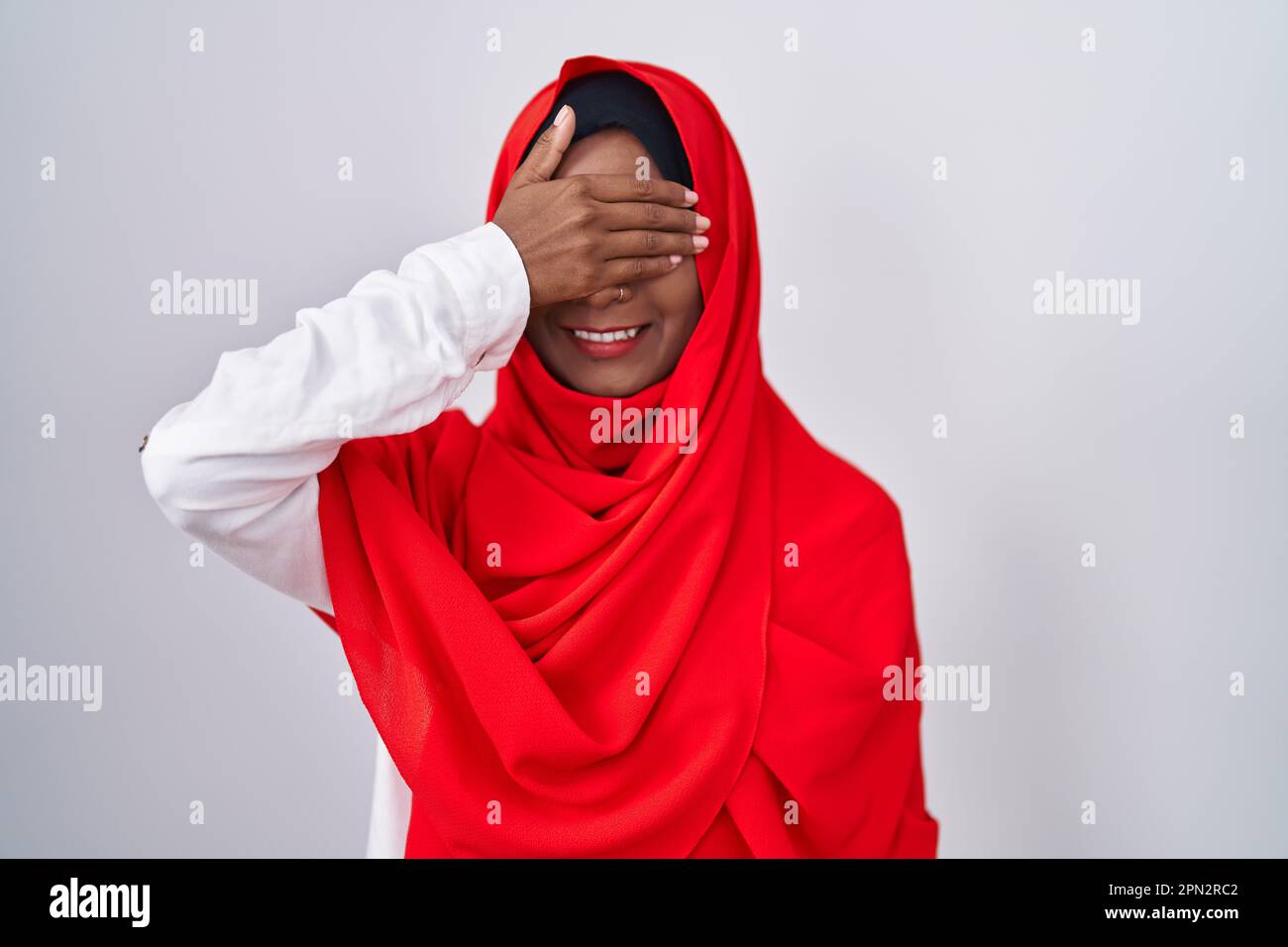 Young arab woman wearing traditional islamic hijab scarf smiling and ...