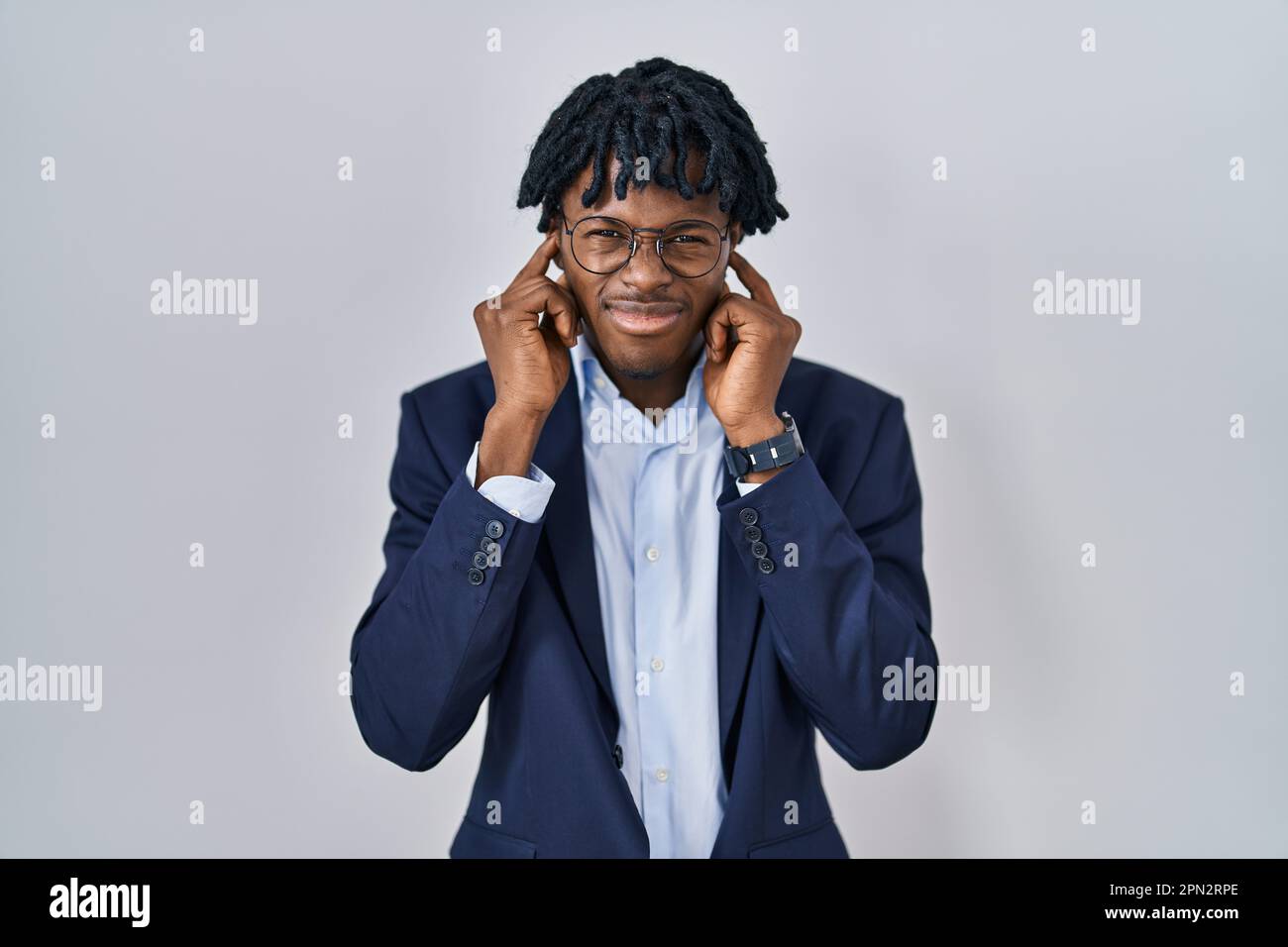 Young african man with dreadlocks wearing business jacket over white ...