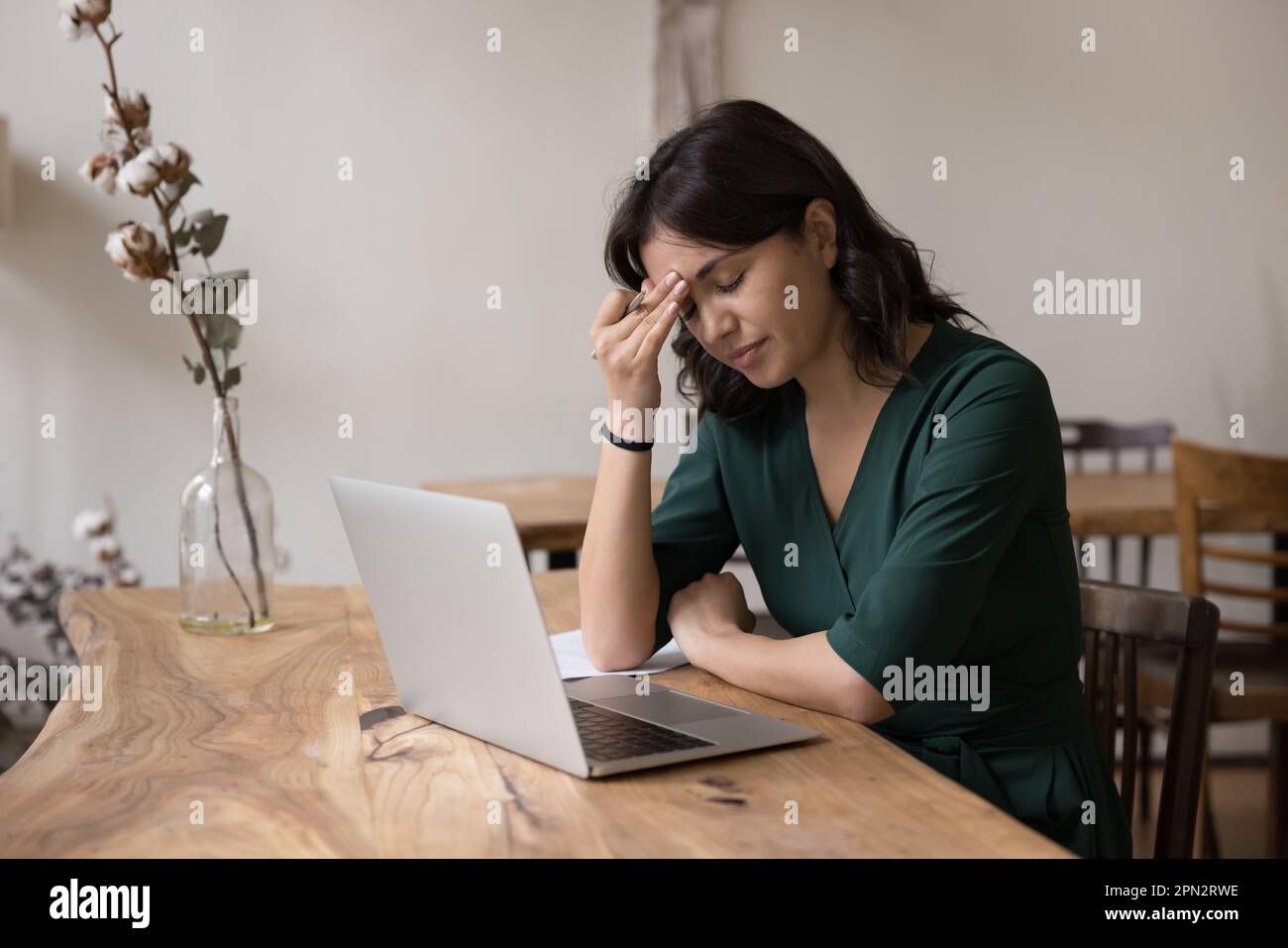 Upset woman suffers from headache and emotional stress at work Stock ...