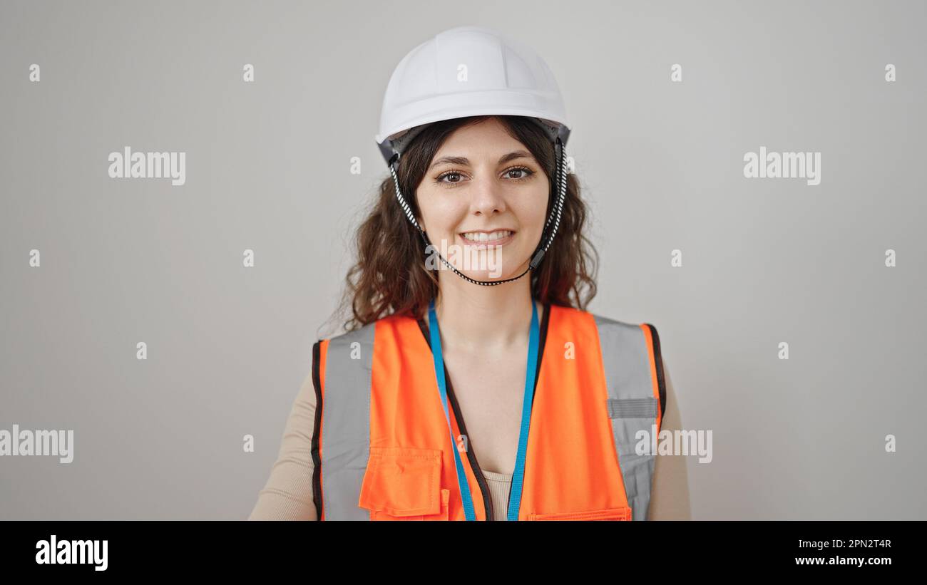 Young beautiful hispanic woman builder smiling confident standing over ...