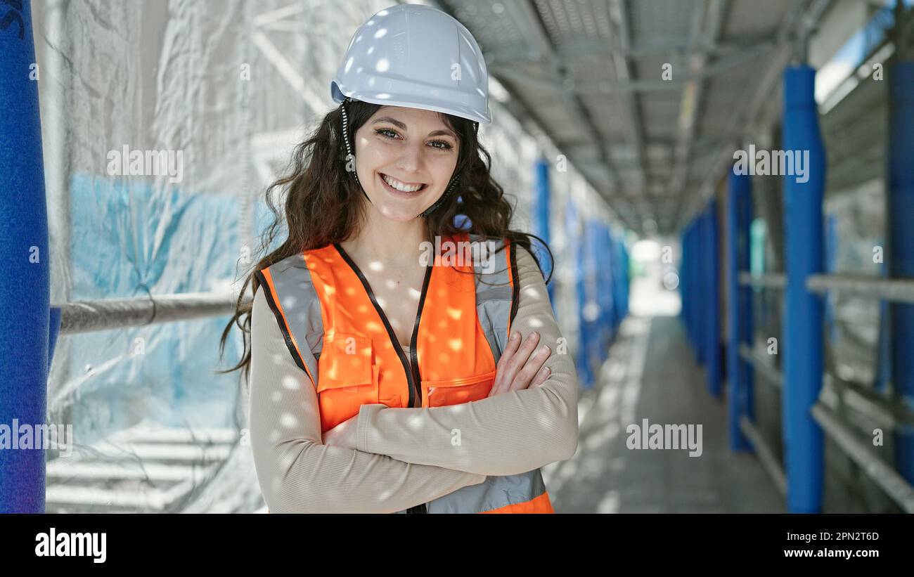 Young beautiful hispanic woman builder smiling confident standing with ...