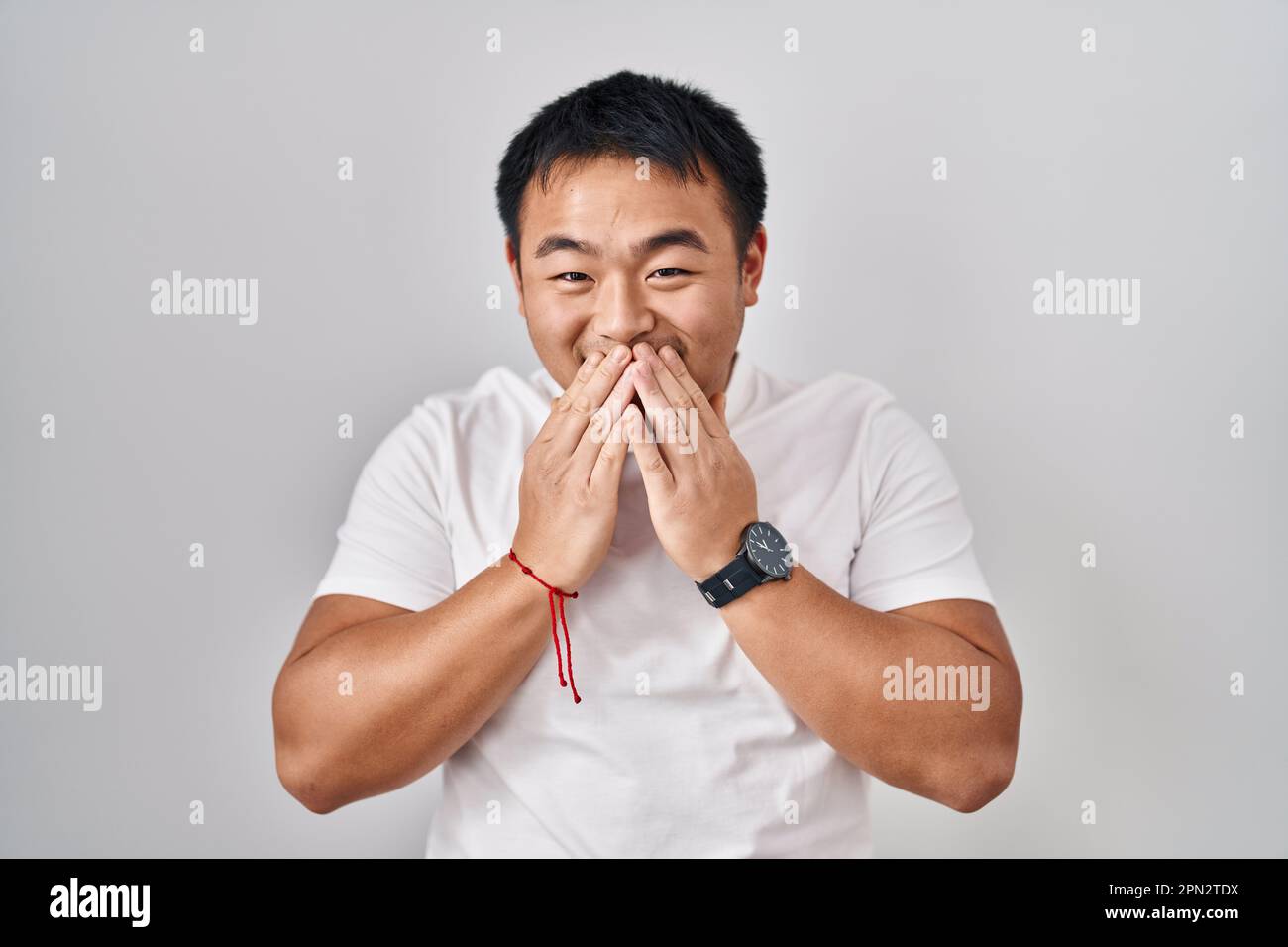 Young chinese man standing over white background laughing and ... Young chinese man standing over white background laughing and ...