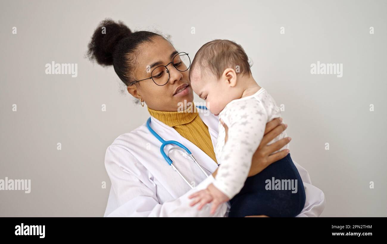 Mother and son doctor holding baby on arms over isolated white ...