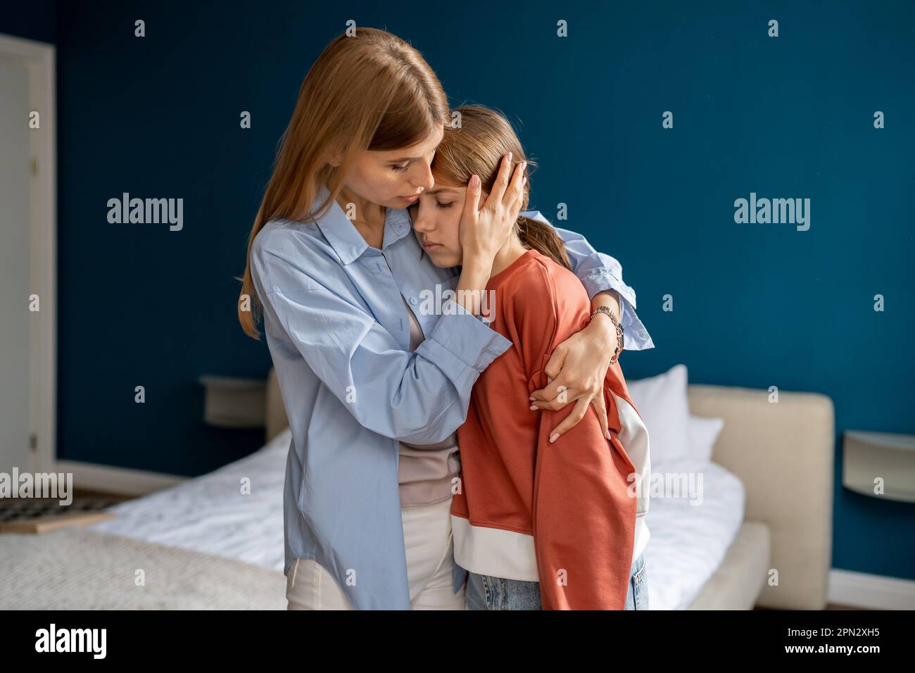 Loving supportive mother hugging upset teen girl daughter, supporting mom child in difficult ...
