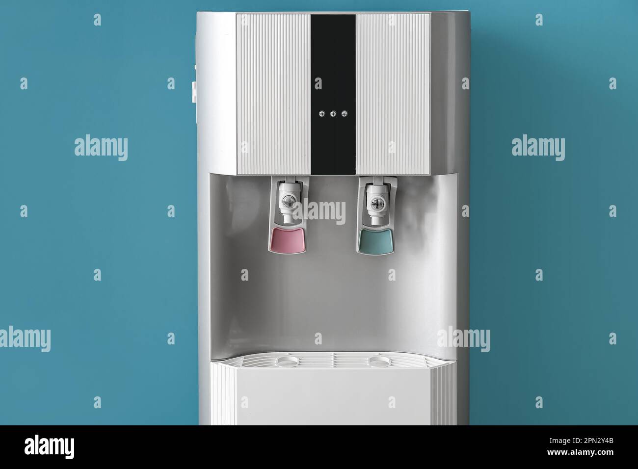 Modern water cooler on blue background Stock Photo - Alamy