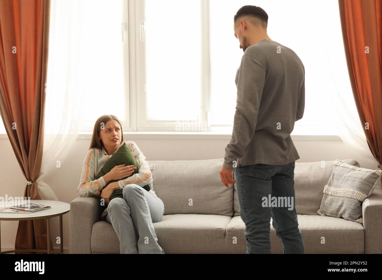 Young woman afraid of her husband at home. Domestic violence concept Stock Photo - Alamy