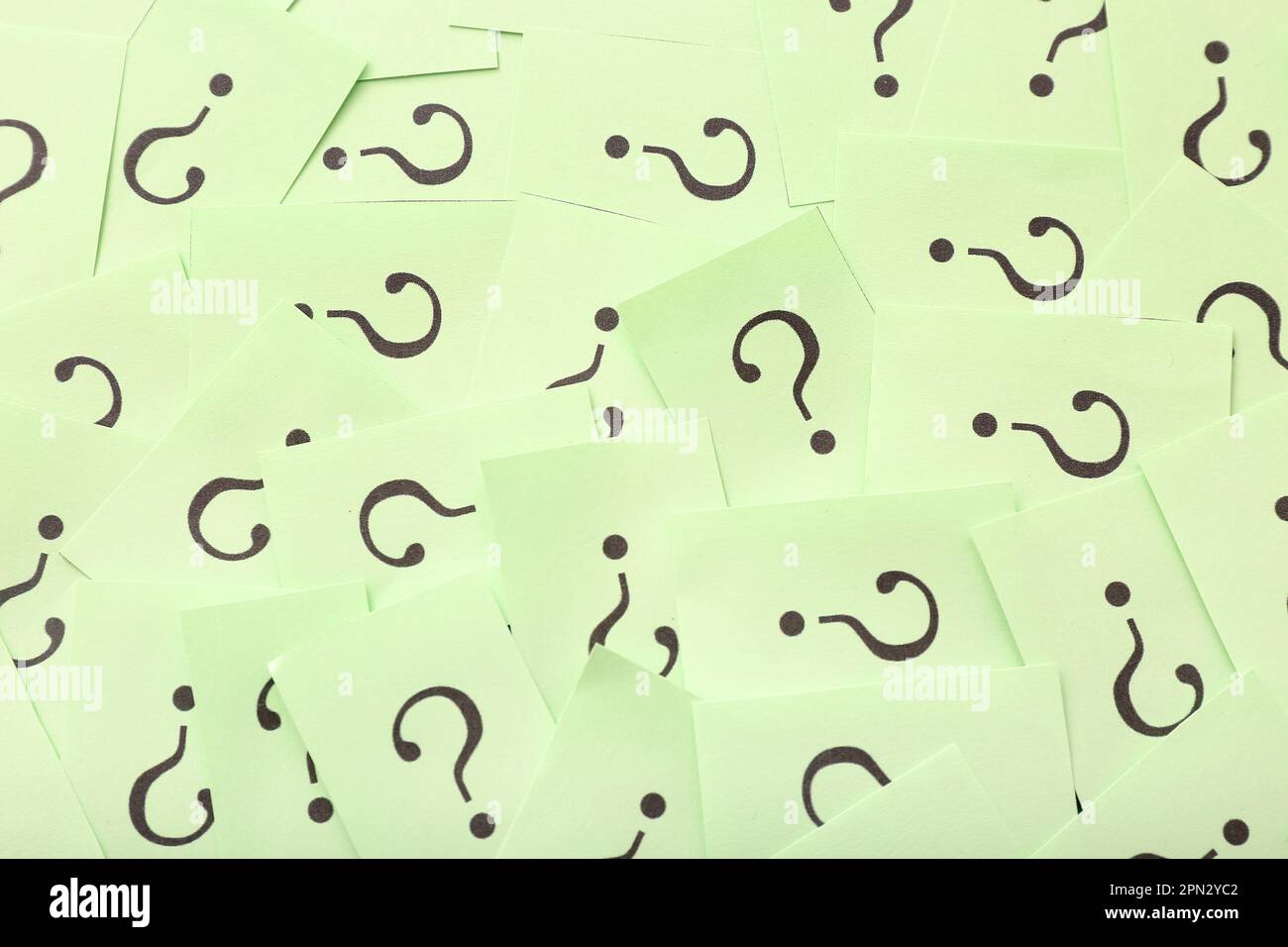 Green papers with question marks as background Stock Photo - Alamy