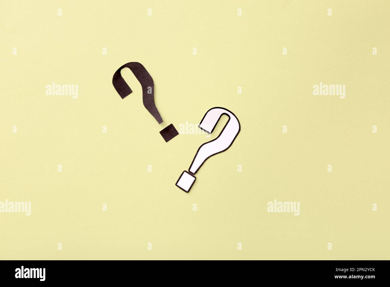Paper question marks on yellow background Stock Photo - Alamy