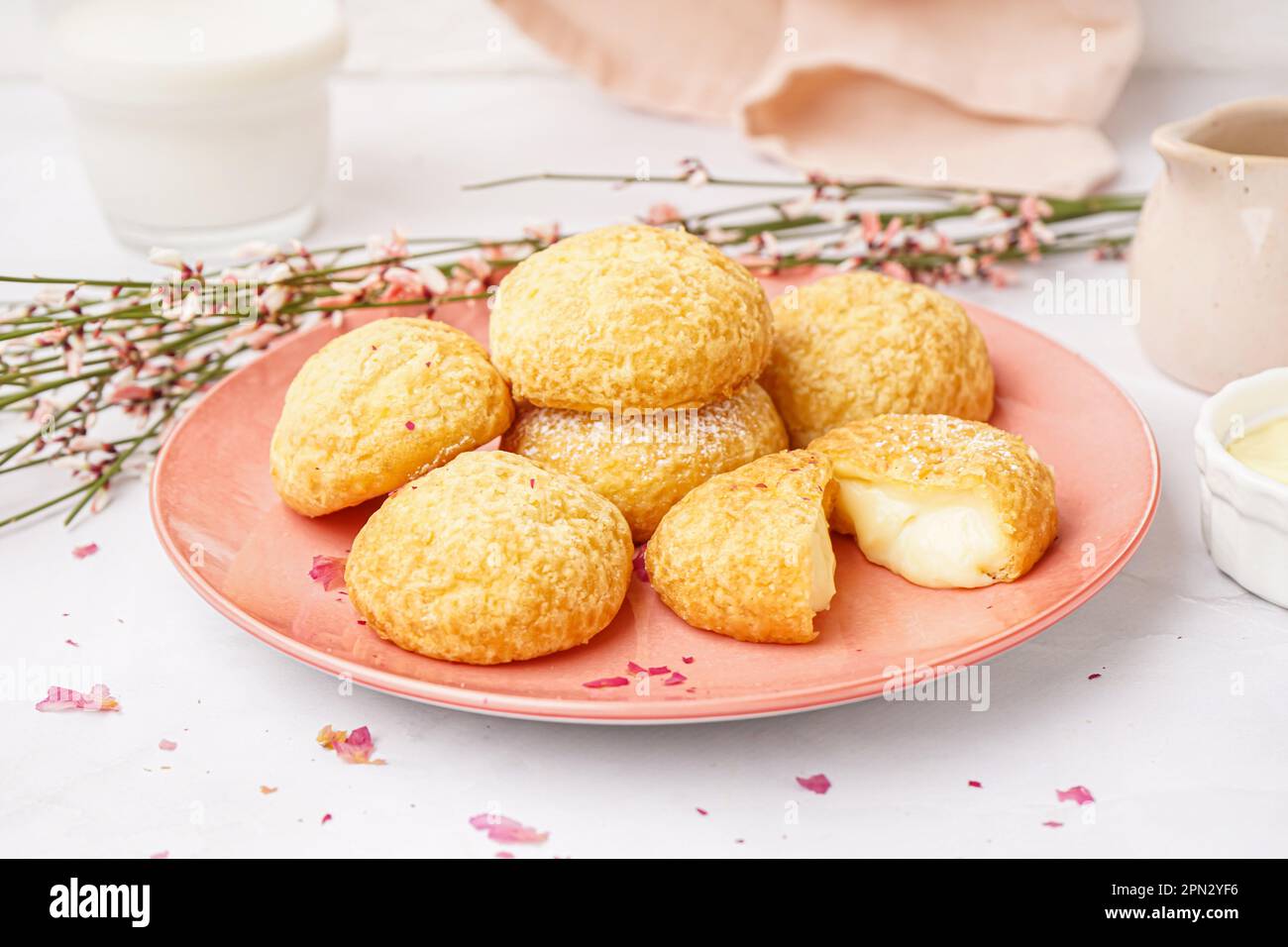 Plate with tasty choux dessert on white background Stock Photo - Alamy