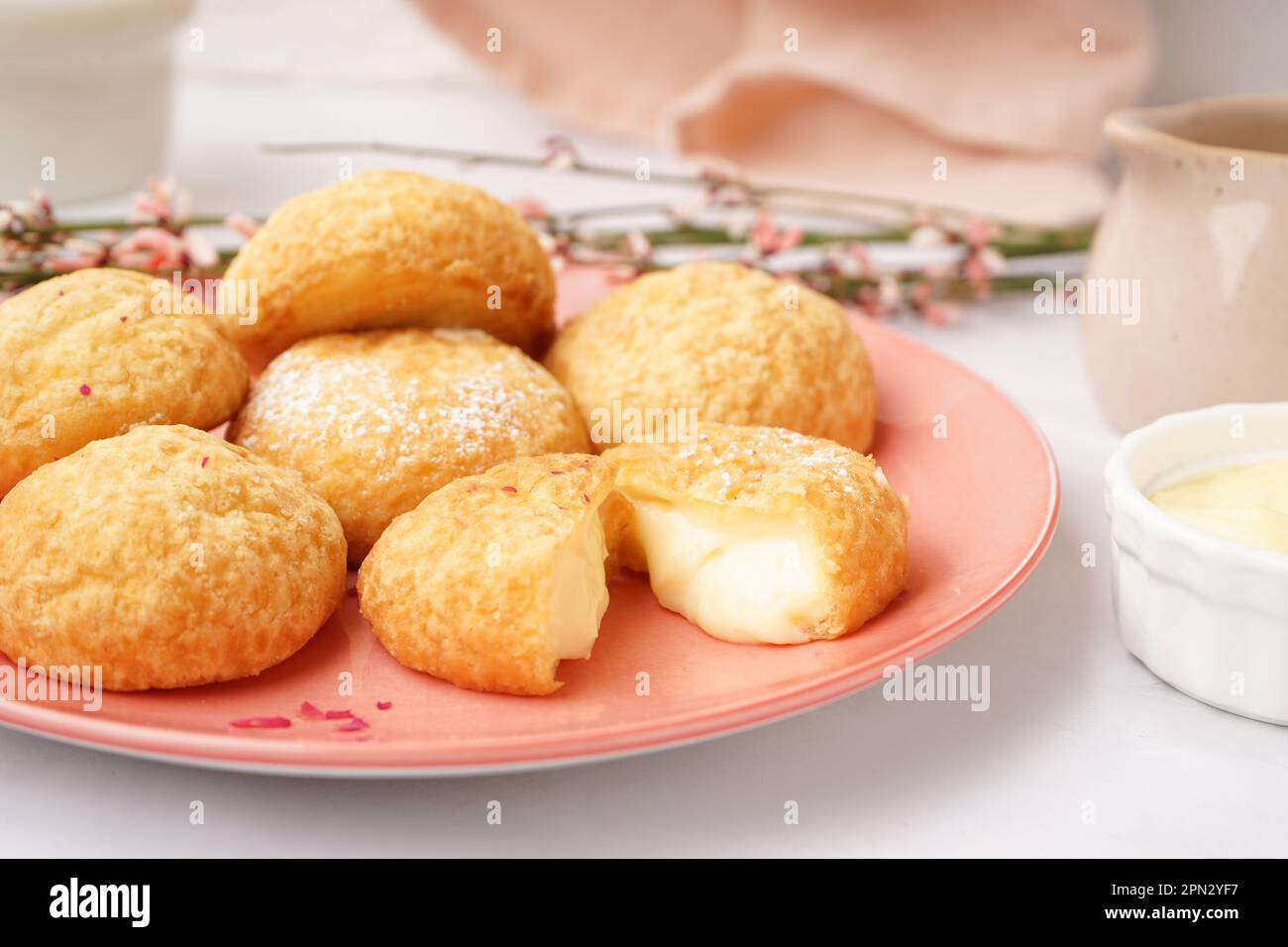 Plate with tasty choux dessert on white background Stock Photo - Alamy