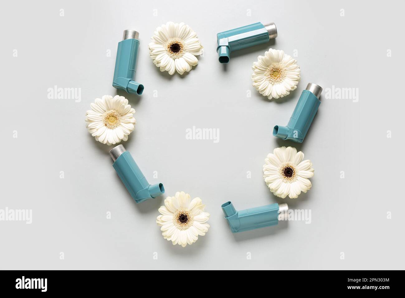 Frame made of inhaler with flowers on grey background Stock Photo - Alamy