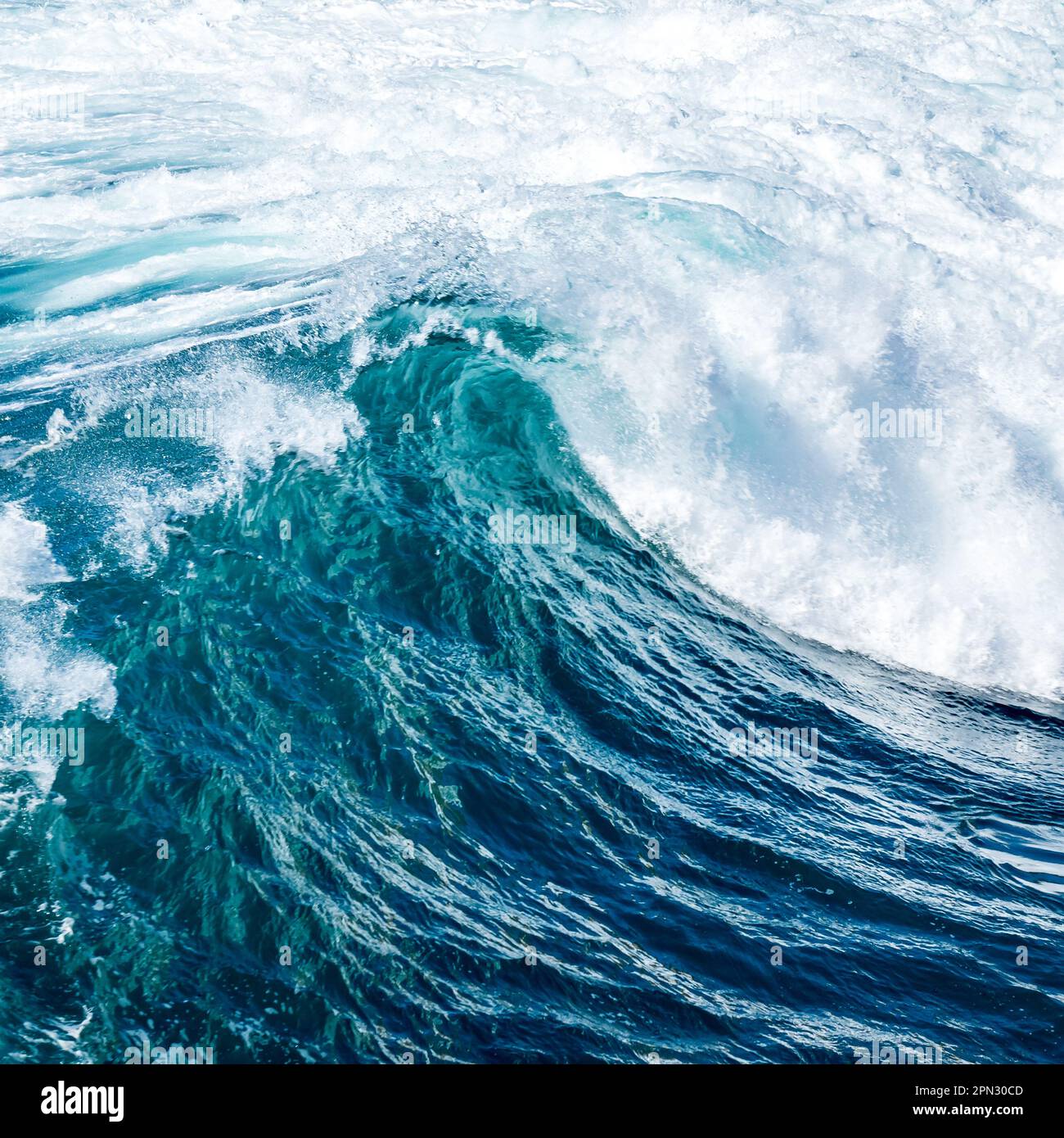 Side view of a wave crashing with great force, producing a magnificent ...