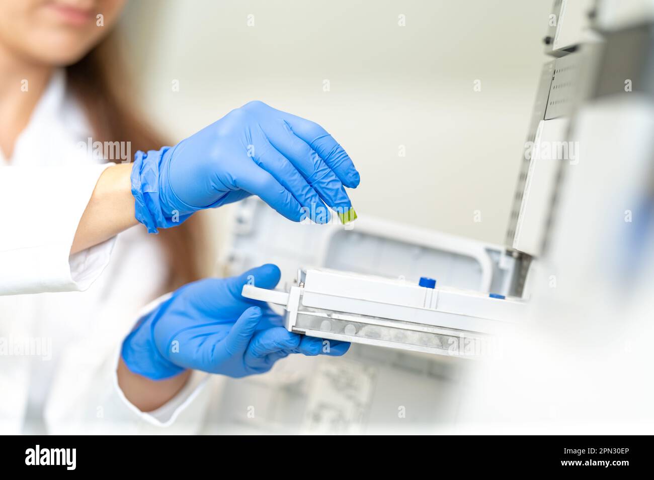 Inserting sample in modern microscope hi-res stock photography and ...