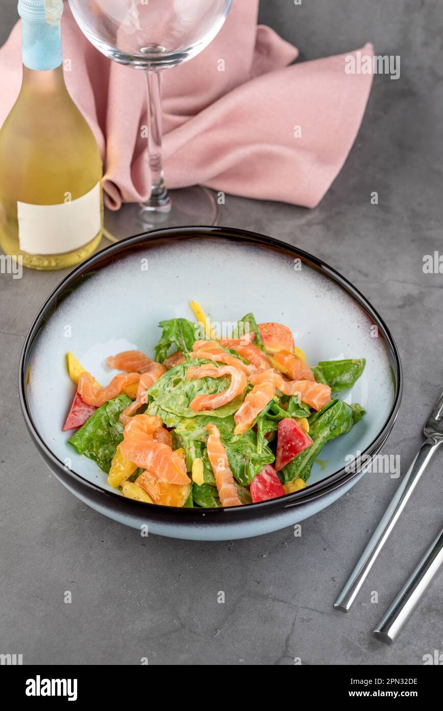 Salmon salad on stone table in fine dining restaurant Stock Photo - Alamy