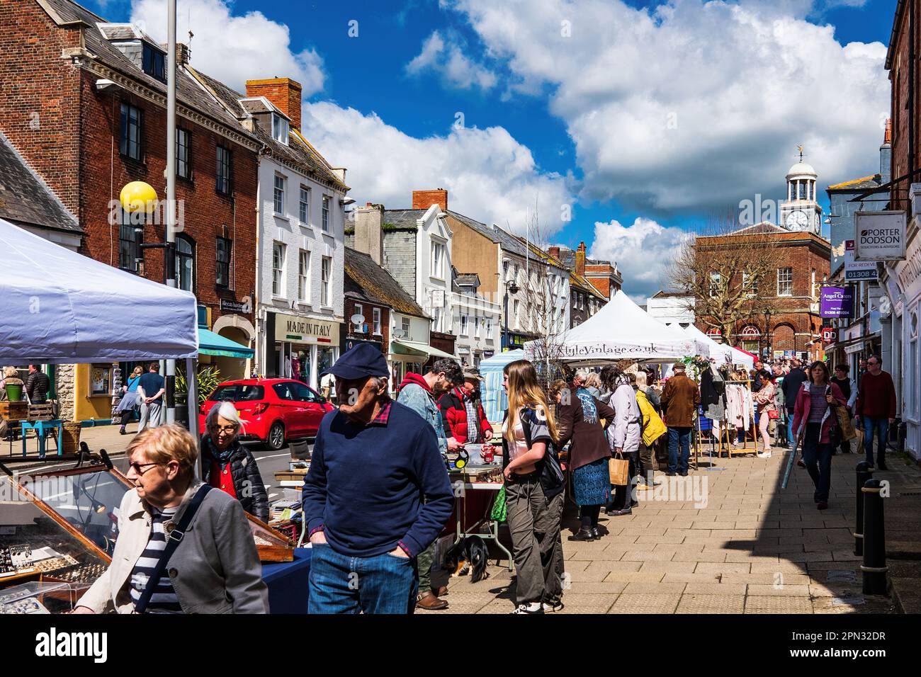 Bridport Saturday street market on a sunny Springtime morning, with the ...